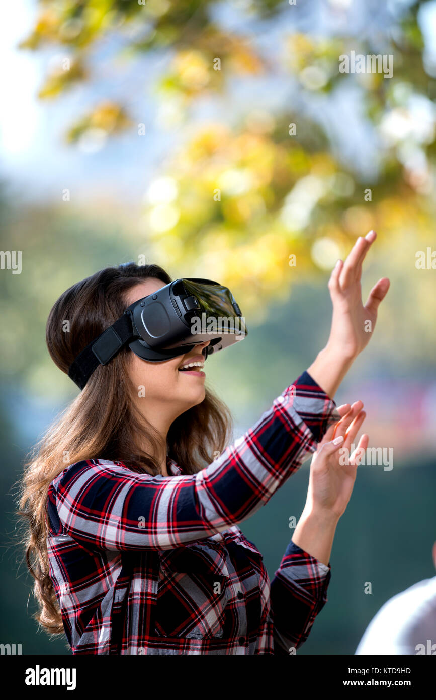 Pretty girl using VR headset outside in the park having fun Stock Photo ...