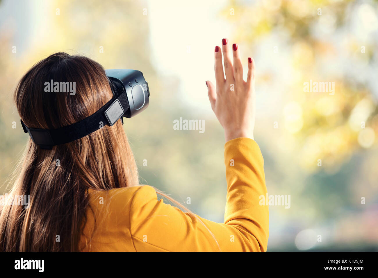 Pretty girl using VR headset outside in the park having fun Stock Photo ...