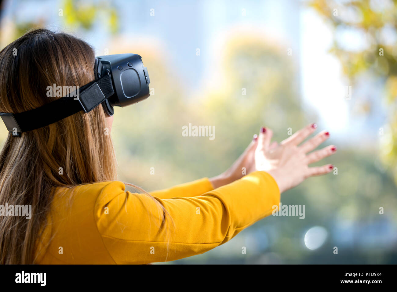 Pretty girl using VR headset outside in the park having fun Stock Photo ...