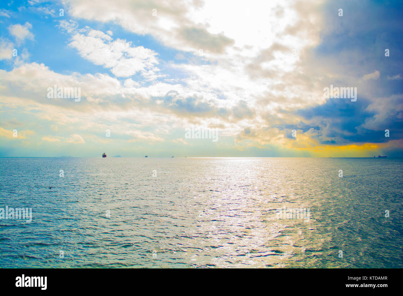 smooth sea with sunset time and some could Stock Photo - Alamy