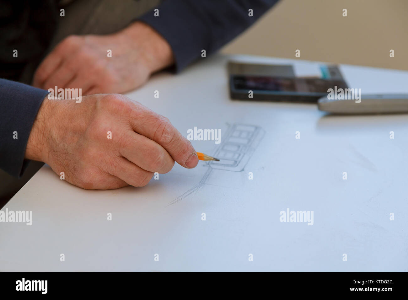 Architect draws a plan projection initial preparatory stage in ...