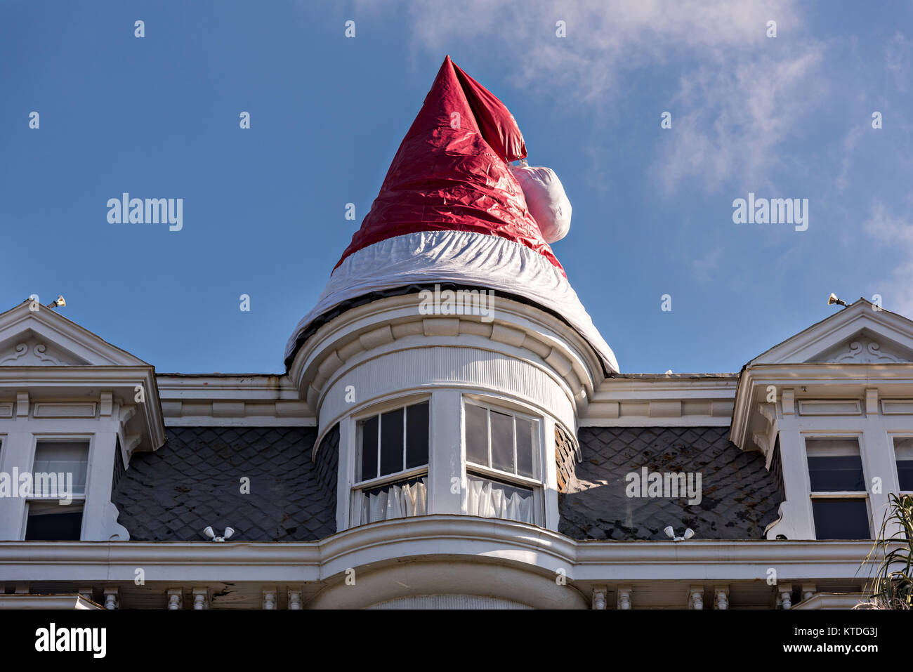 A giant Santa Hat decorates the peaked roof on a historic home ...