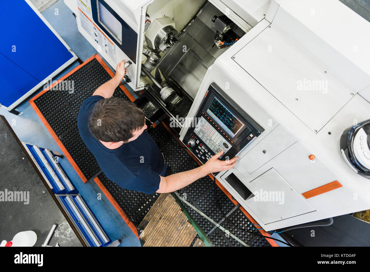 Top view of man operating machine in industrial factory Stock Photo - Alamy