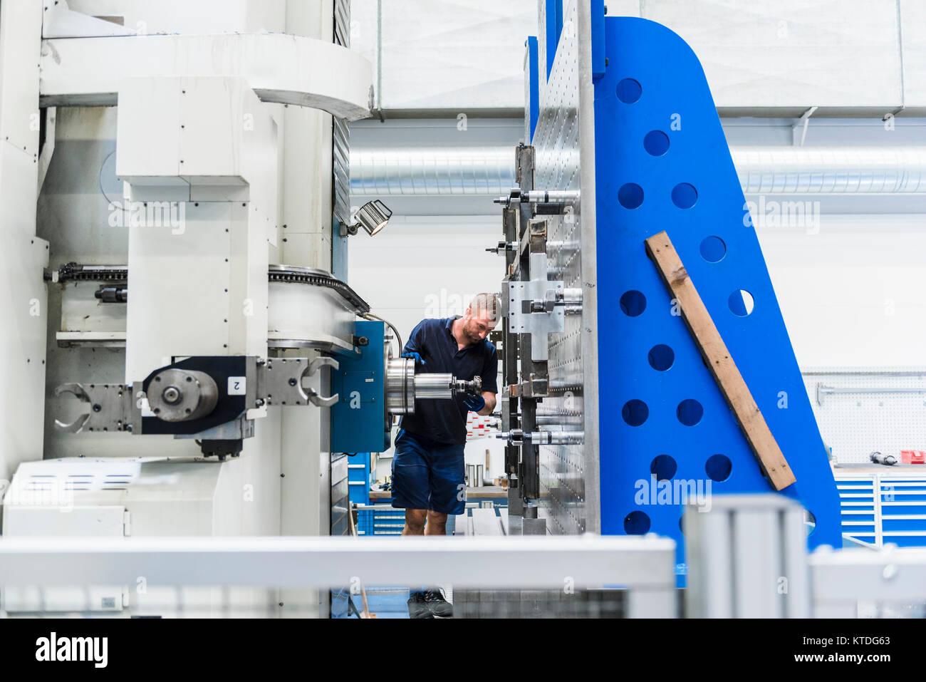 Man working on machine in industrial factory Stock Photo - Alamy