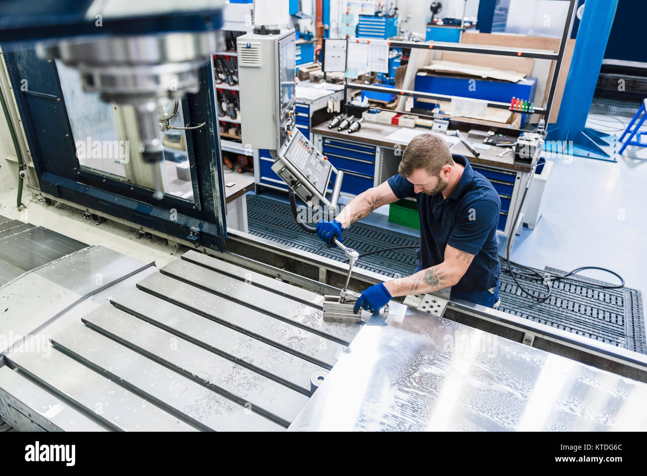 Man working on machine in industrial factory Stock Photo - Alamy