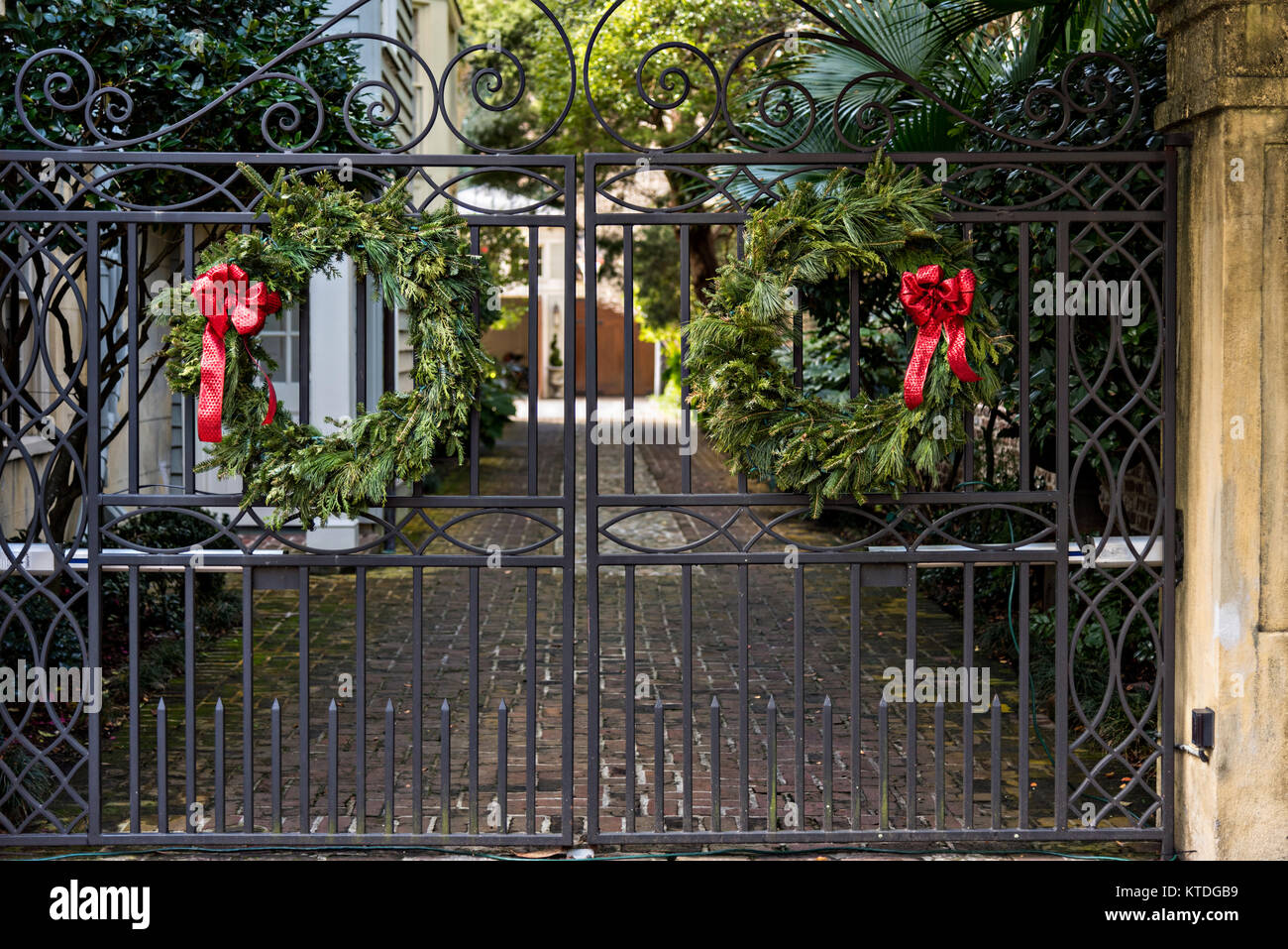 The wrought iron gate of a historic home decorated with Christmas ...