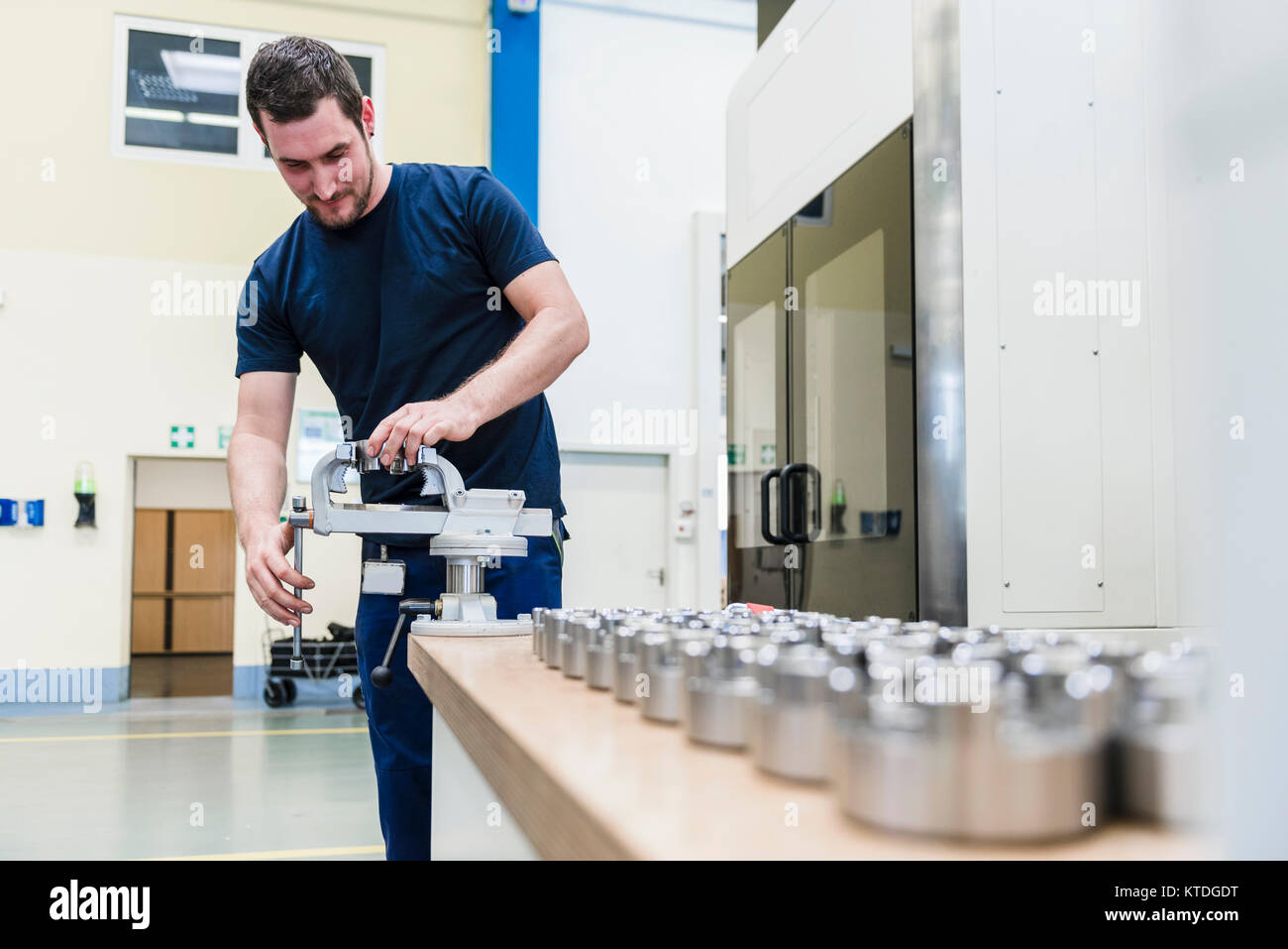Man working with vice at workbench Stock Photo - Alamy