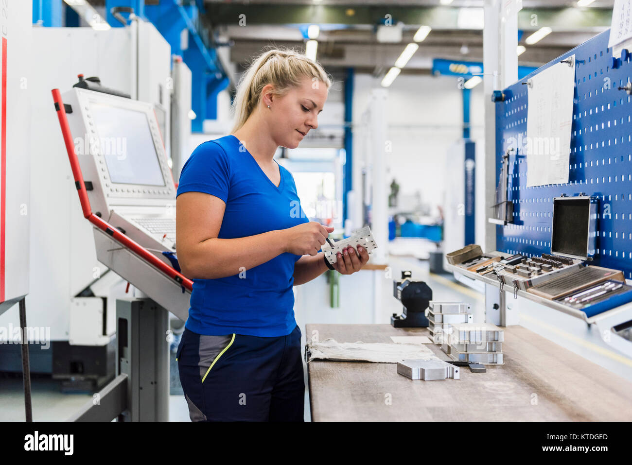 Woman working in industrial factory Stock Photo - Alamy