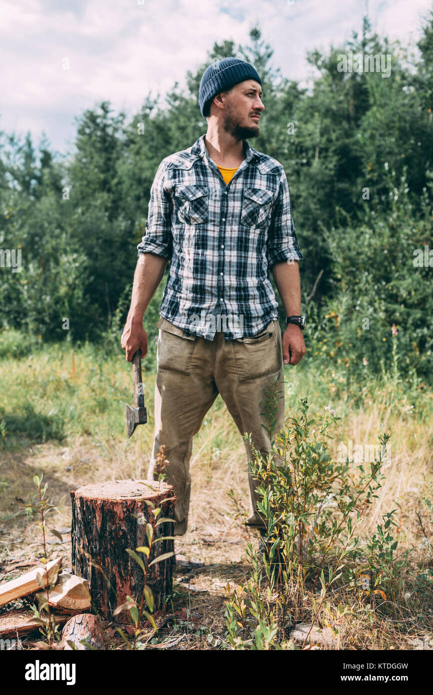 Man chopping wood in rural landscape Stock Photo - Alamy