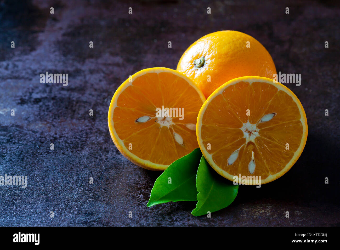 Organic oranges in halves on dark background Stock Photo - Alamy