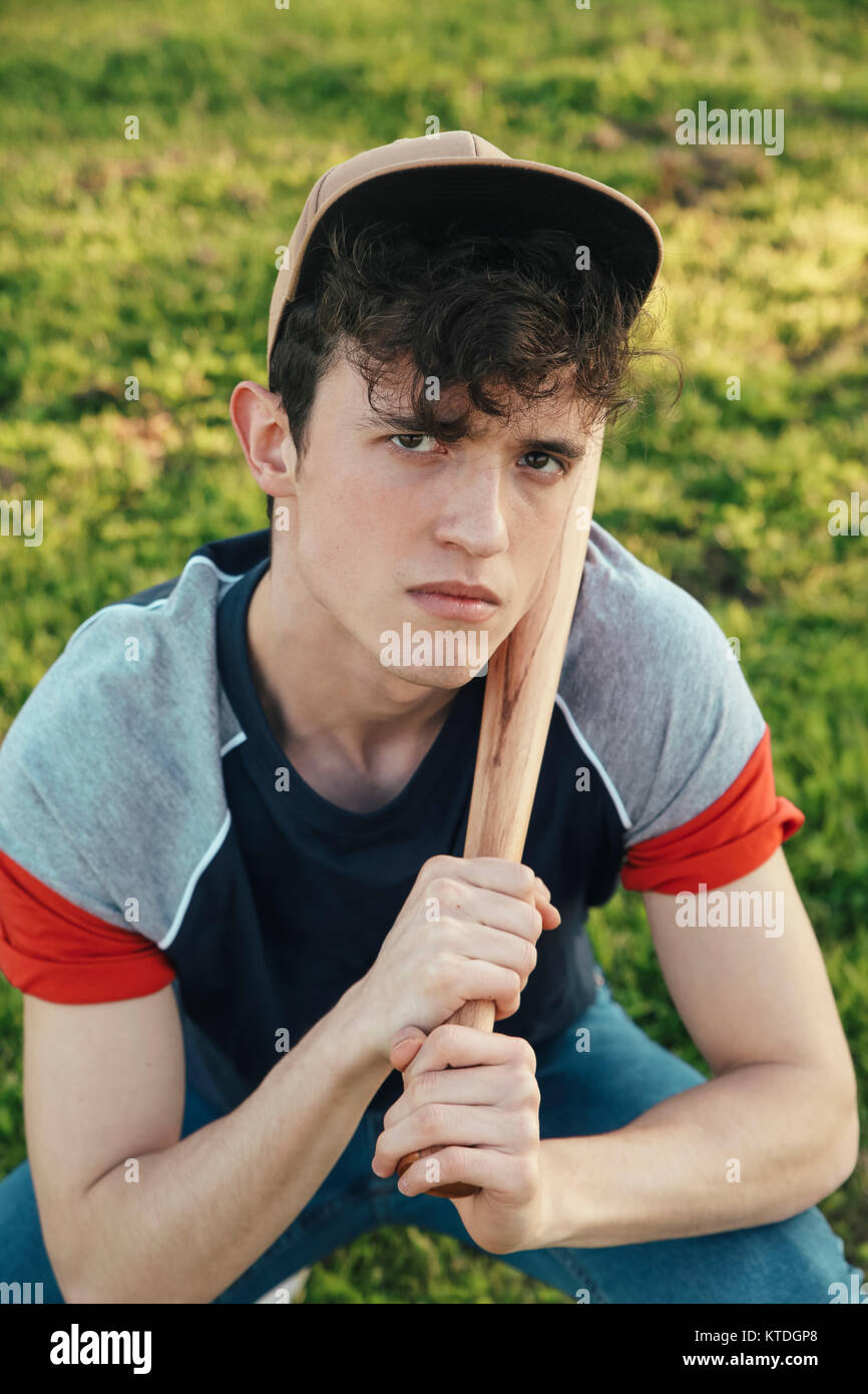 Portrait of young man with baseball bat Stock Photo - Alamy