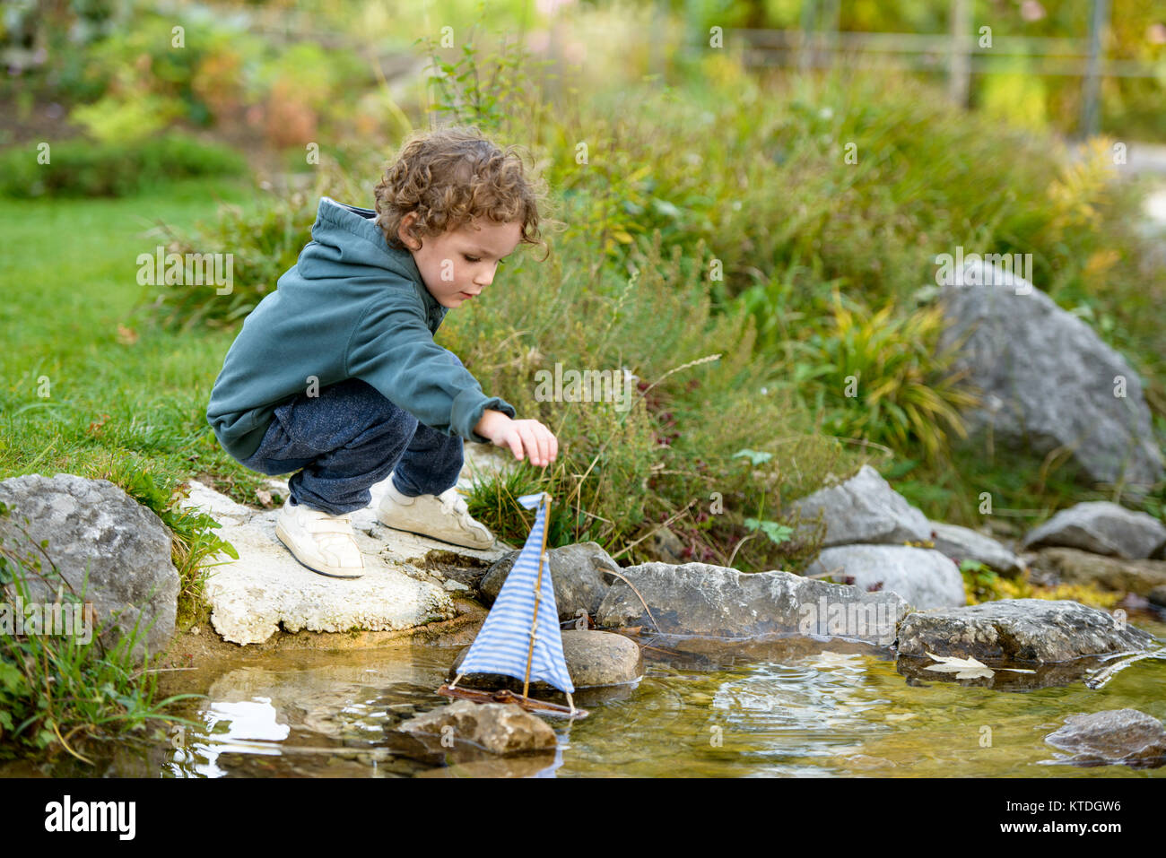 Children playing with sailing boat hi-res stock photography and images ...