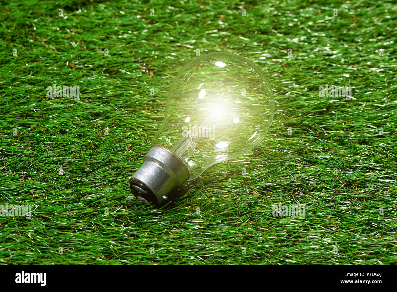 Electric glass bulb on grass background. Ideas creativity concept Stock ...