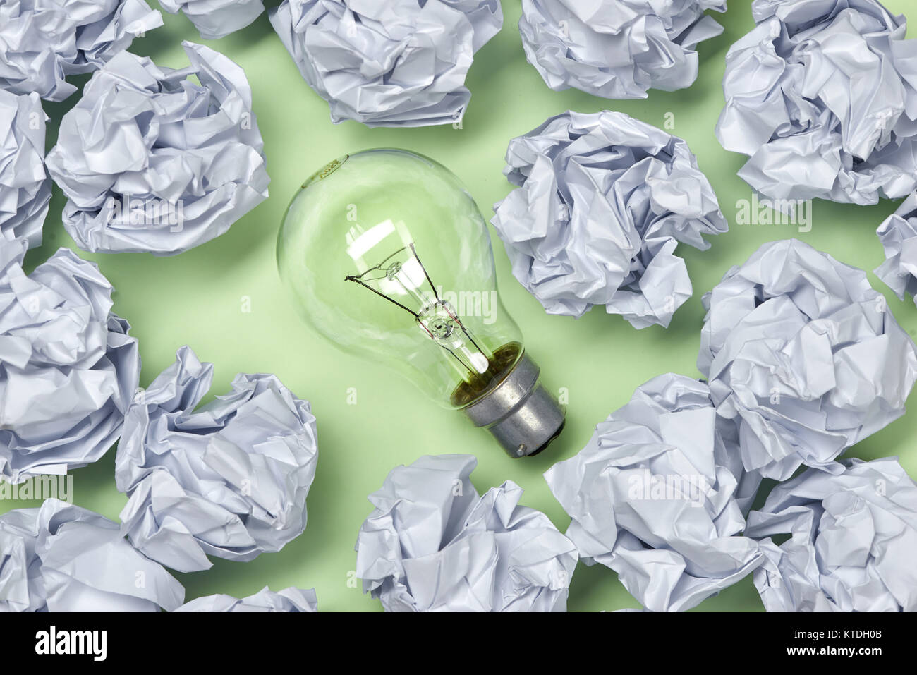 great concept with crumpled office paper and light bulb standing on the ...