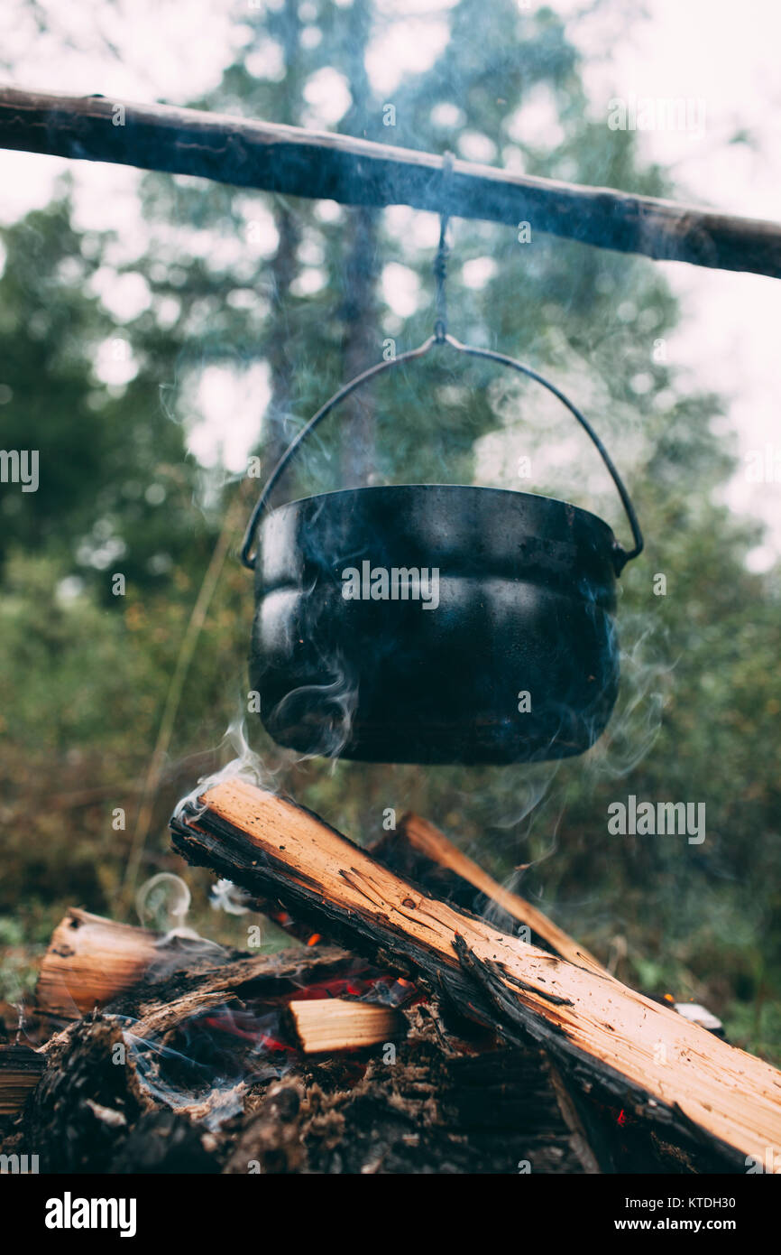 Cauldron over camp fire Stock Photo - Alamy