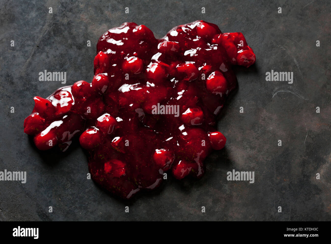 Red fruit compote on dark background Stock Photo - Alamy