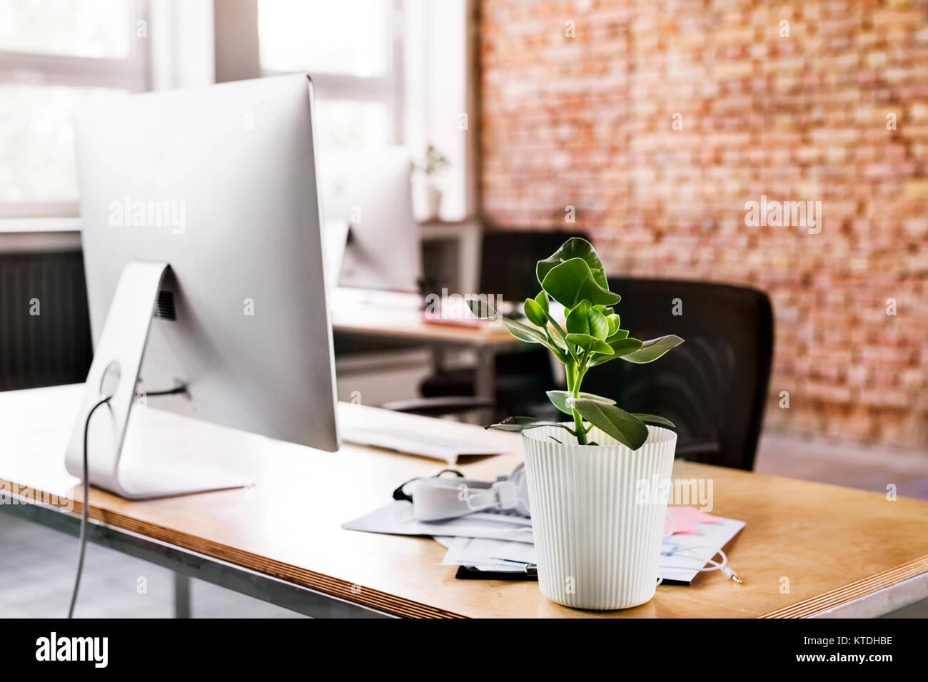Workspace with brick wall in office Stock Photo - Alamy