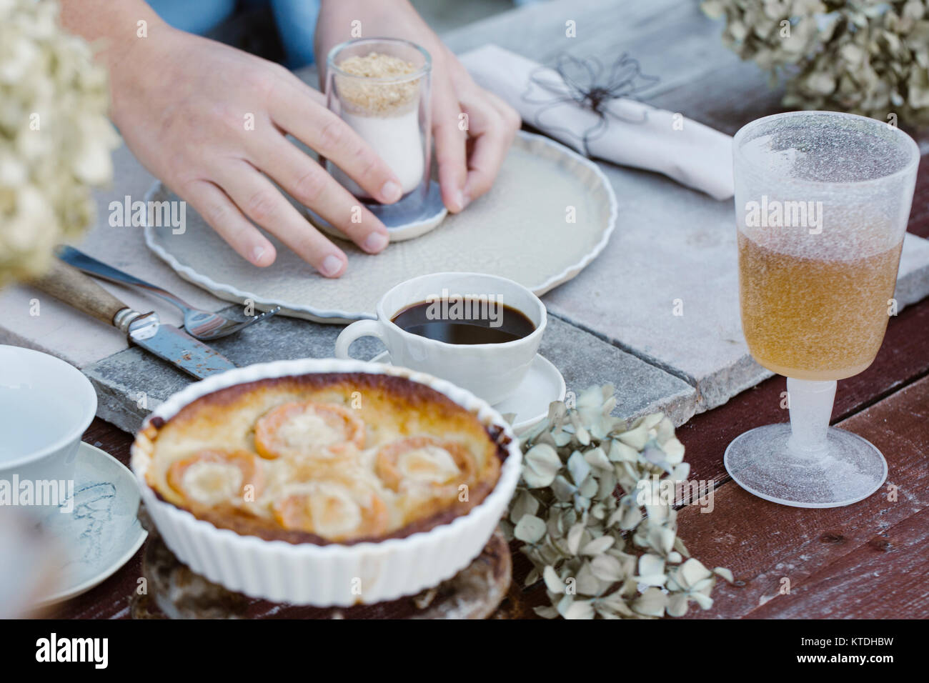 Italy, Italy, woman laying breakfast table, partial view Stock Photo ...