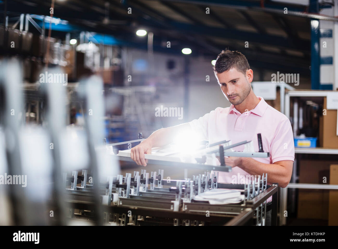 Businessman standing in shop floor, testing products Stock Photo - Alamy