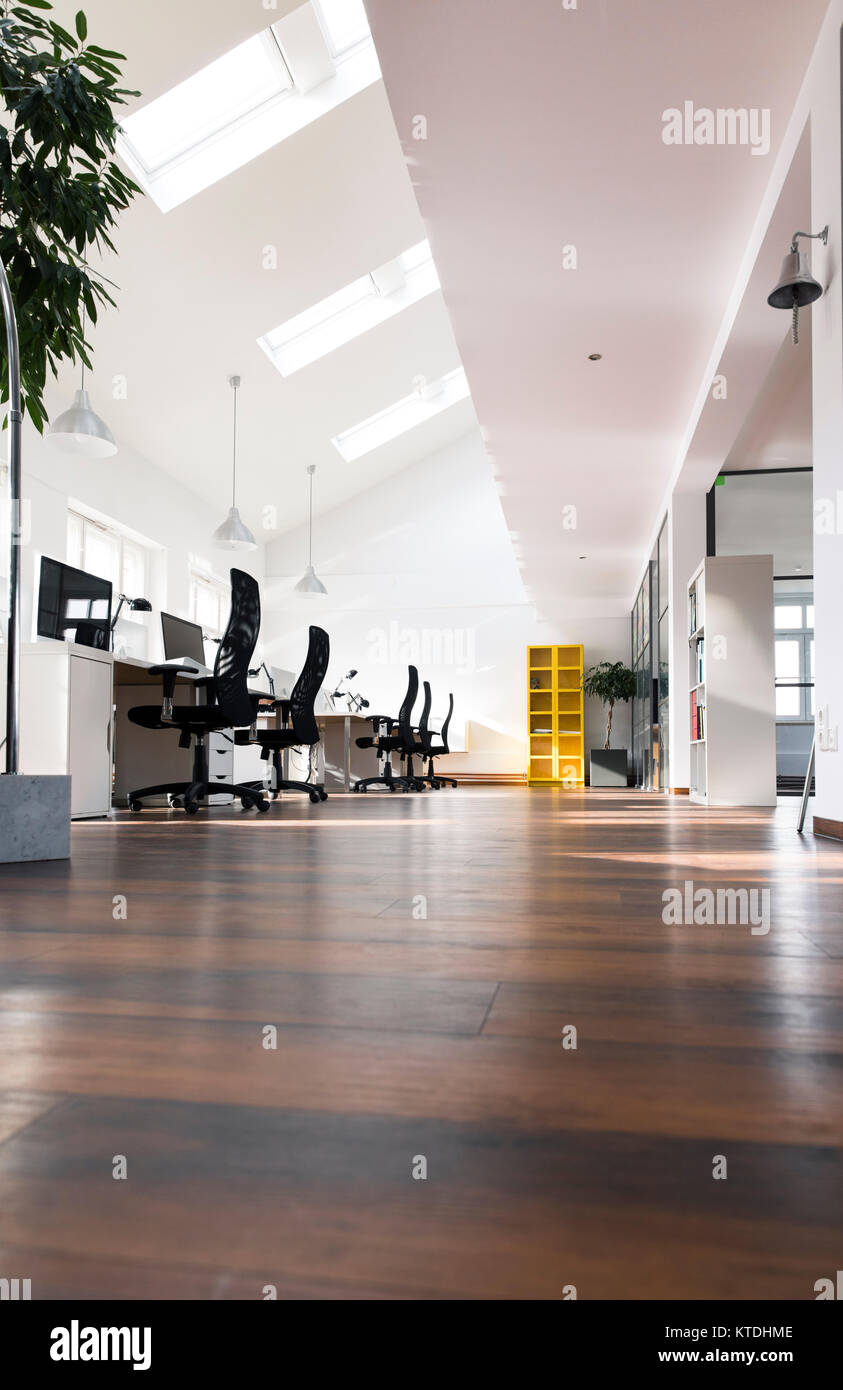 Desks with PCs in bright and modern open space office Stock Photo - Alamy