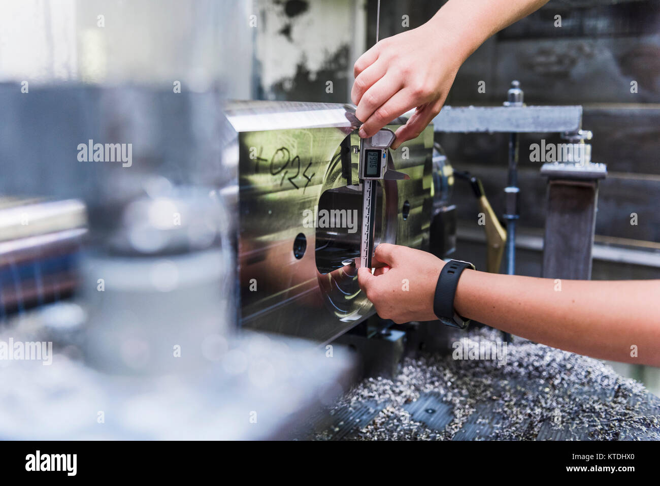 Detail of woman working on machine in industrial factory Stock Photo ...