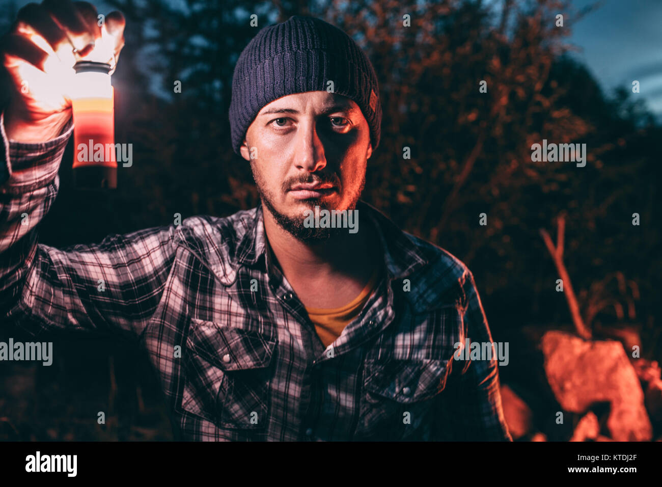 Portrait of serious man with lamp in rural landscape Stock Photo - Alamy