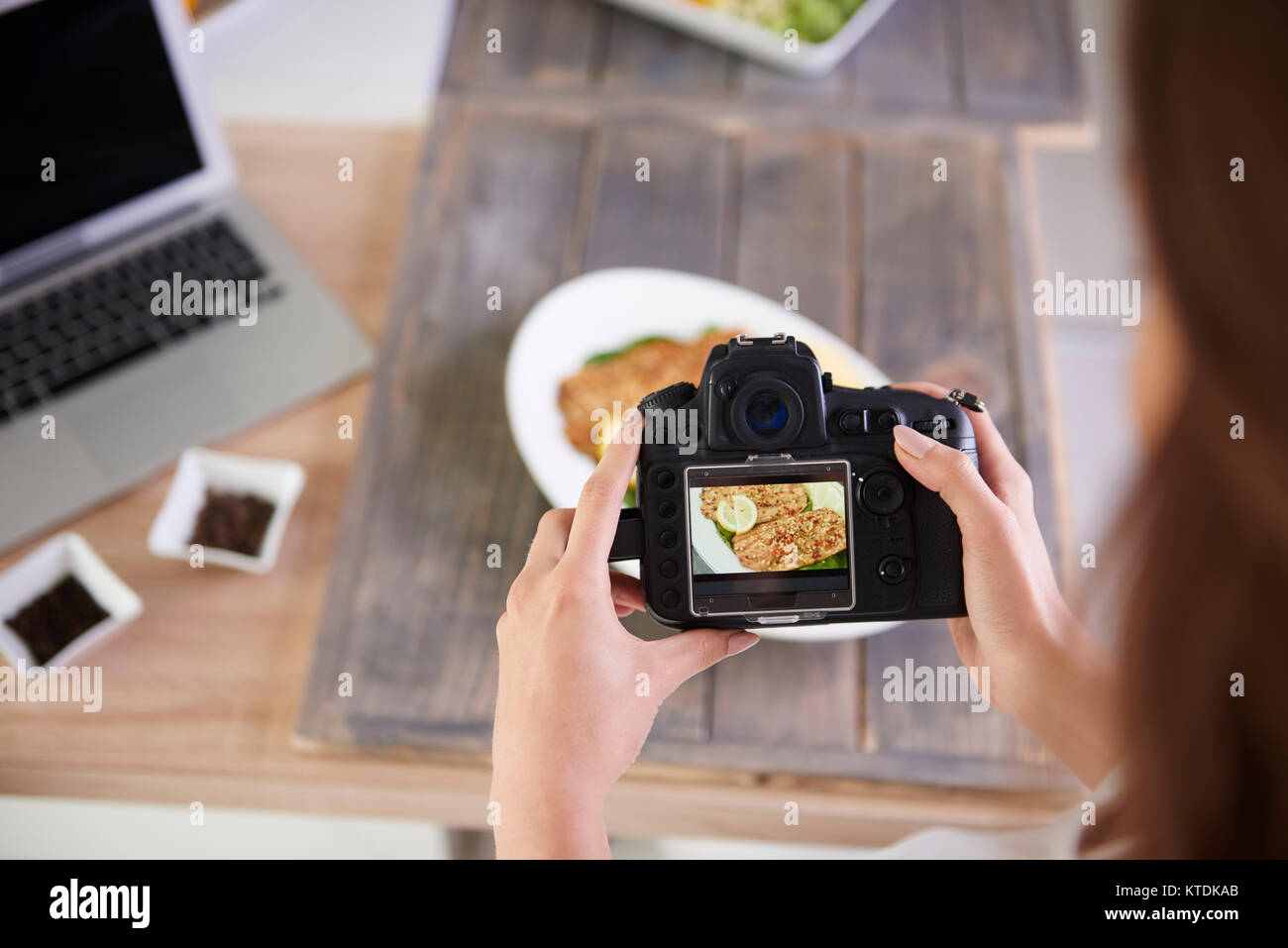 Close-up of woman taking photo of fried fish Stock Photo - Alamy
