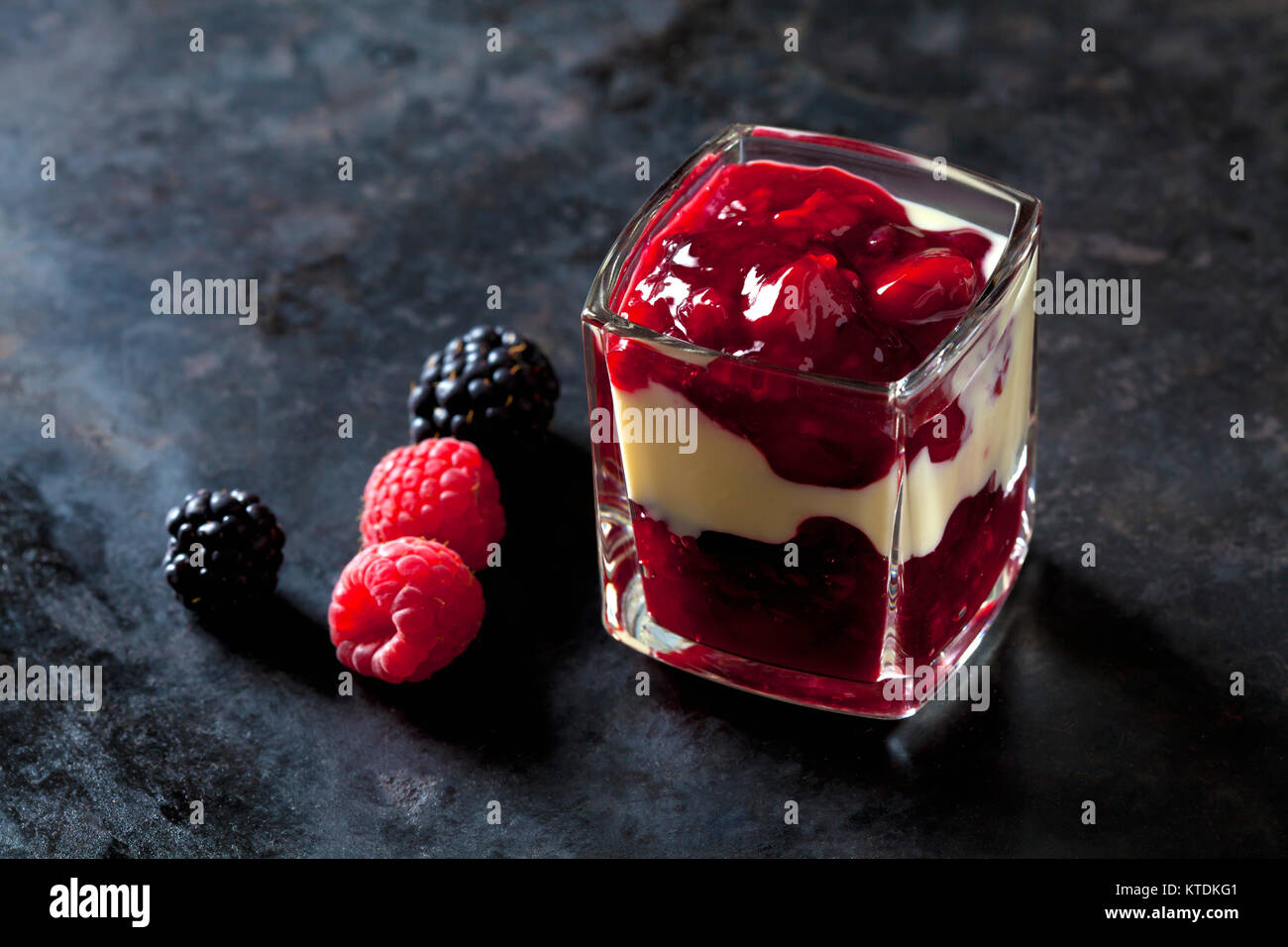 red fruit compote with vanilla sauce layered in a glass Stock Photo - Alamy