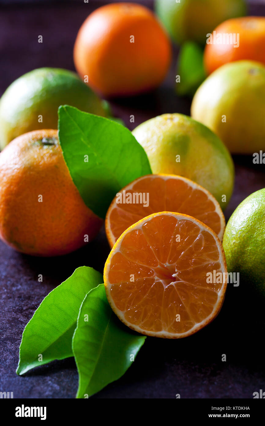 Organic tangerines and lemons on dark background Stock Photo - Alamy