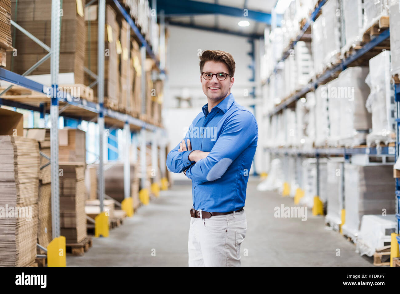 Businessman standing in warehouse, portrait Stock Photo - Alamy