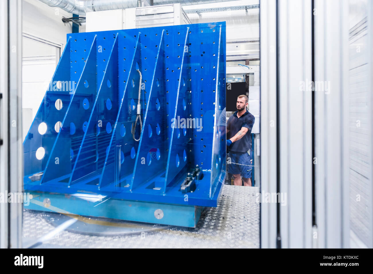 Man operating machine in industrial factory Stock Photo - Alamy