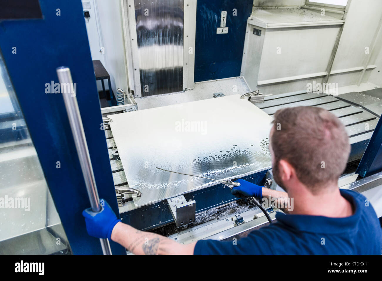 Man working on machine in industrial factory Stock Photo - Alamy