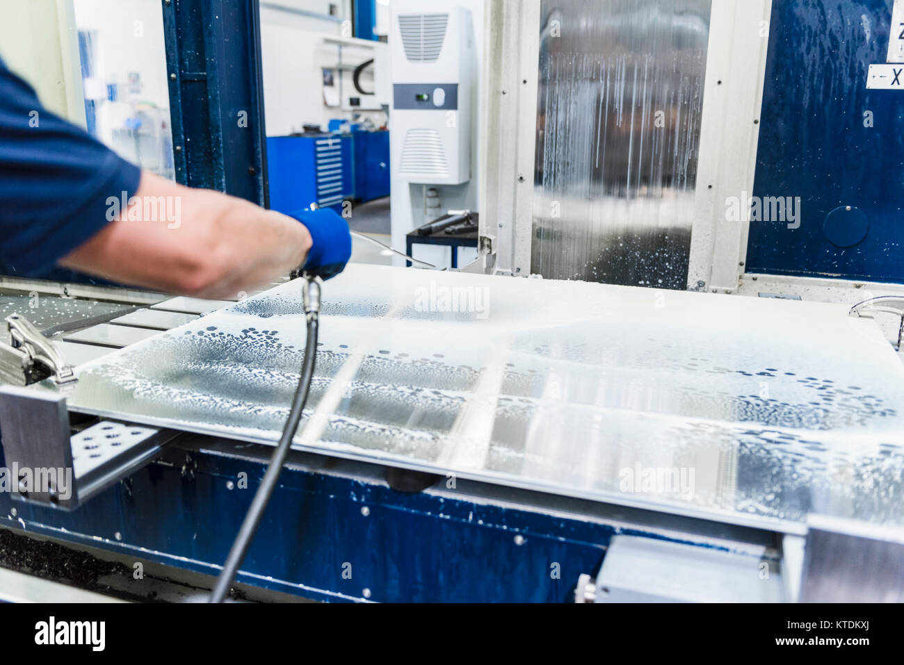 Close-up of man working on machine in industrial factory Stock Photo ...