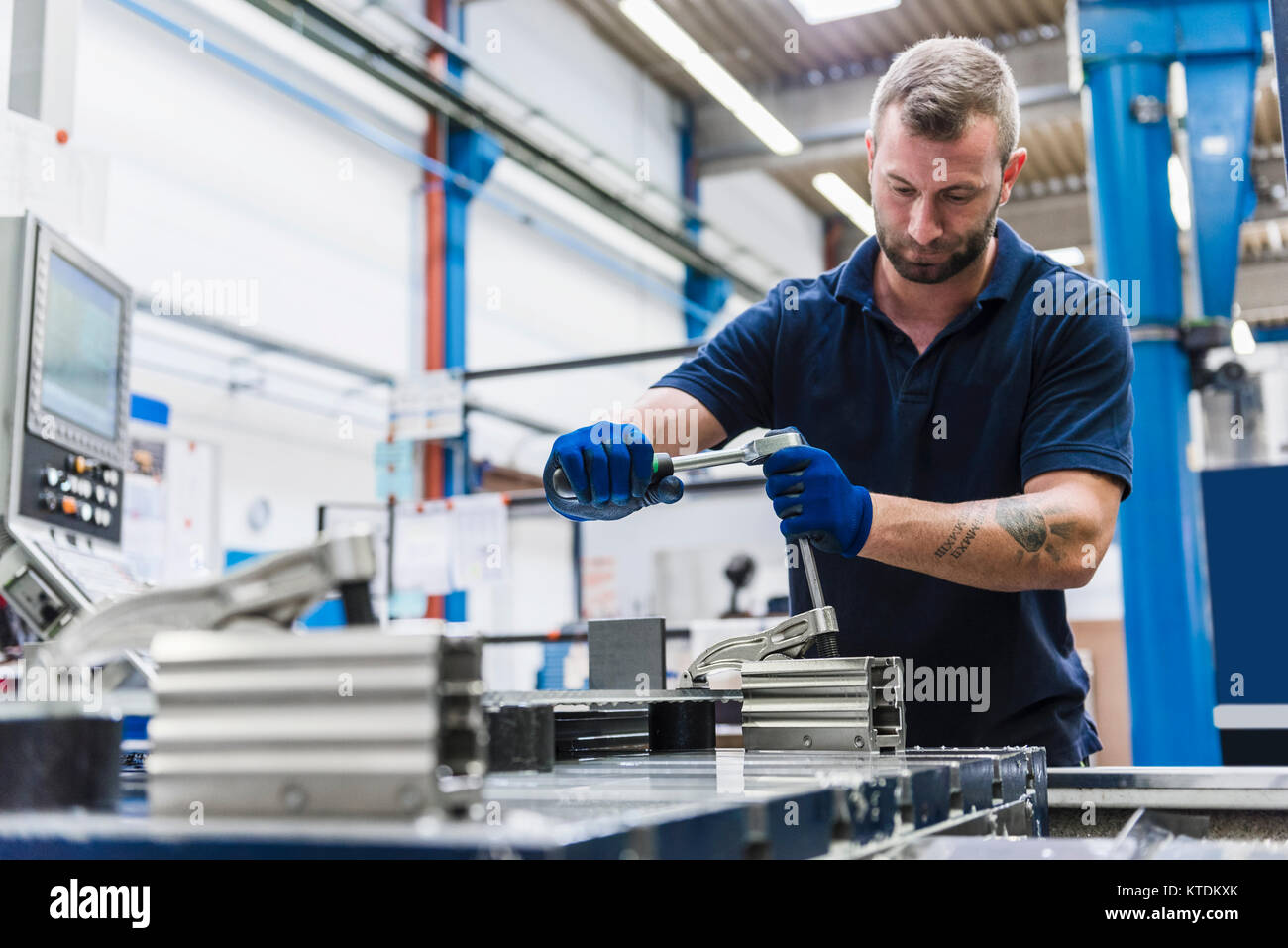Man working on machine in industrial factory Stock Photo - Alamy
