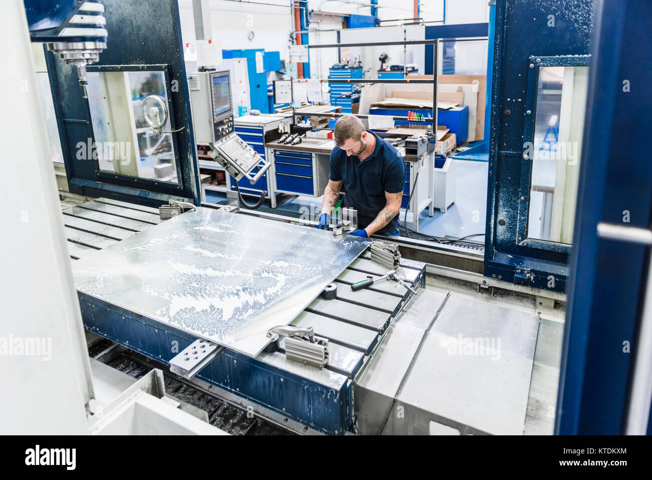 Man working on machine in industrial factory Stock Photo - Alamy