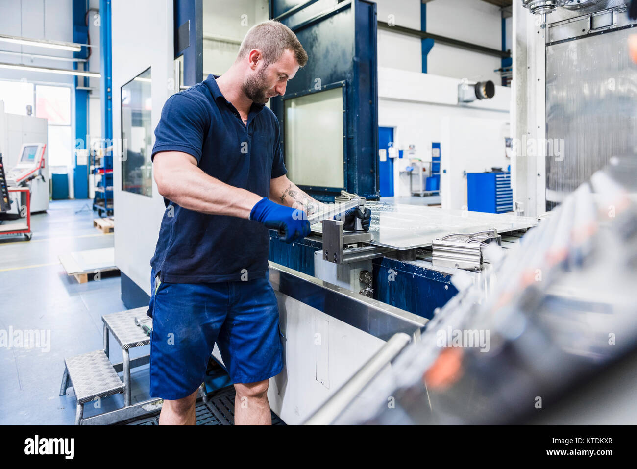 Man working on machine in industrial factory Stock Photo - Alamy