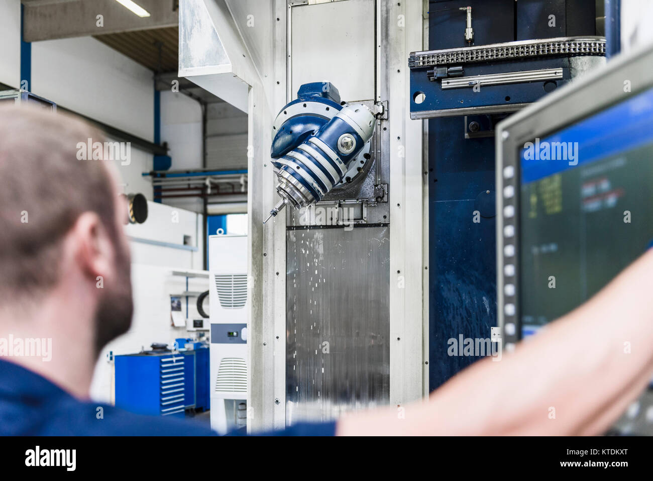 Man operating machine in industrial factory Stock Photo - Alamy