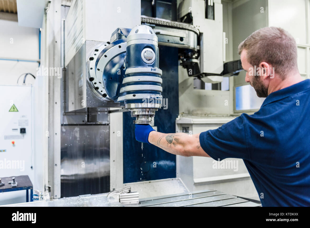 Man working on machine in industrial factory Stock Photo - Alamy