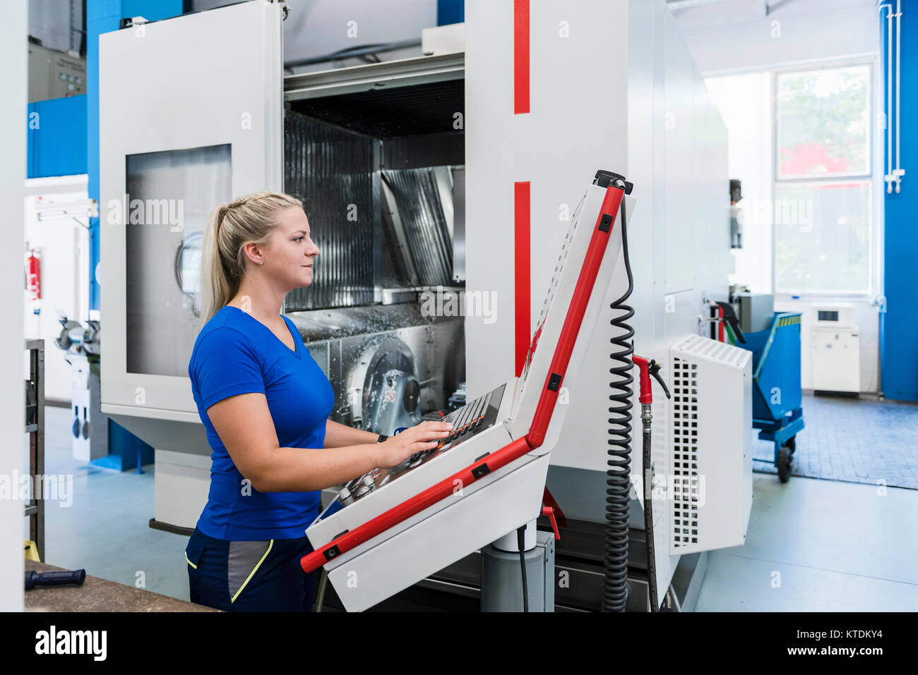 Woman operating control panel in industrial factory Stock Photo - Alamy