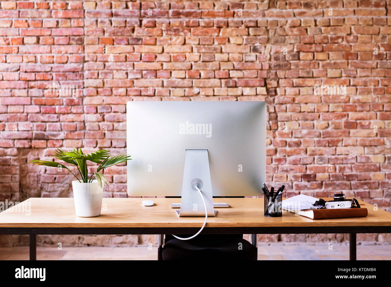 Workspace with brick wall in office Stock Photo - Alamy