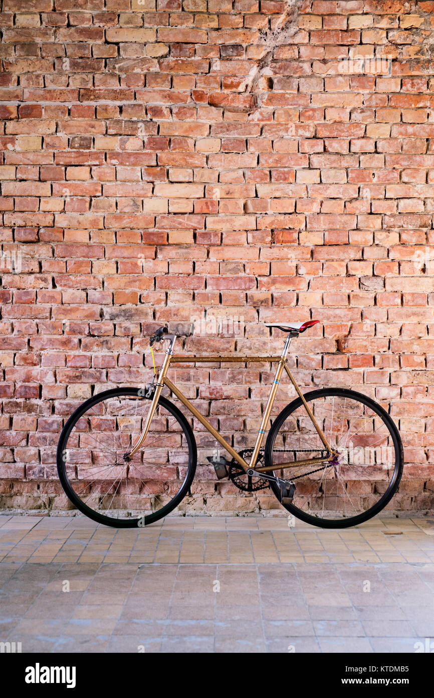 Bicycle at brick wall in office Stock Photo - Alamy