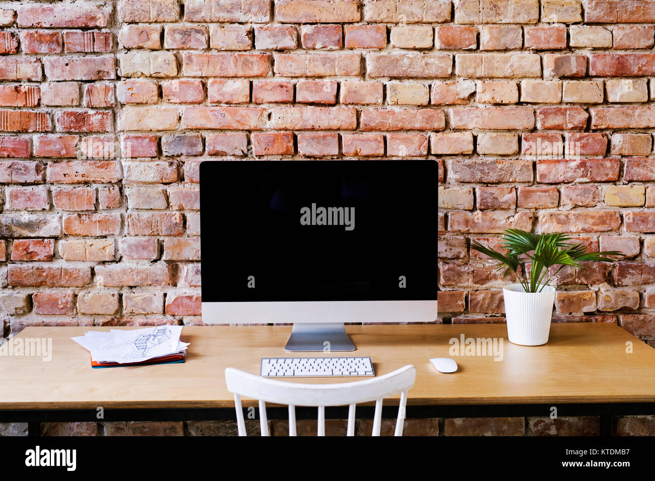 Workspace at brick wall in office Stock Photo - Alamy
