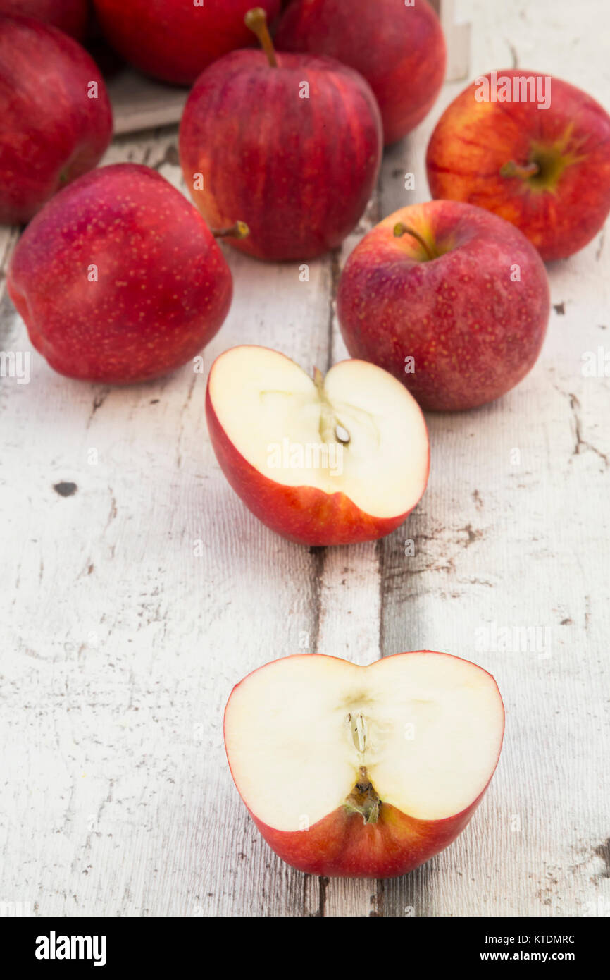Red apples on wood, halved Stock Photo - Alamy