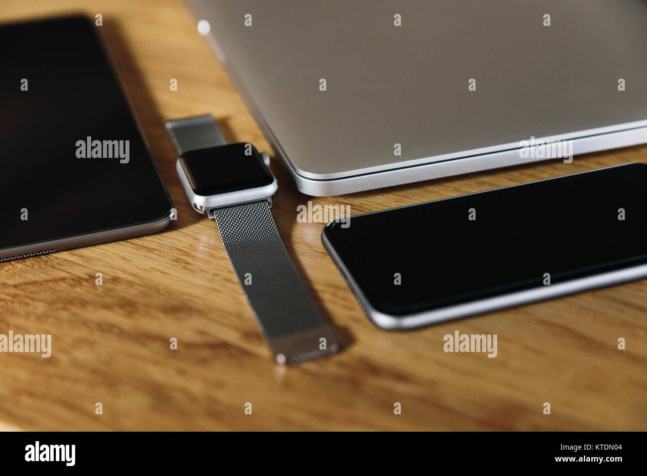 Tablet, smartwatch, smartphone, and laptop on wood Stock Photo - Alamy