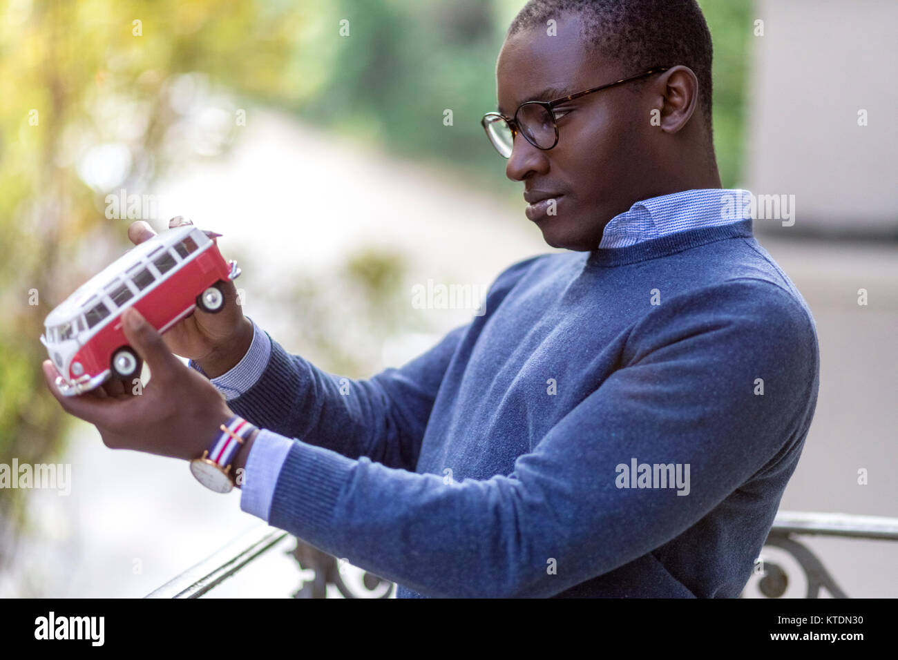 Man with model car on balcony Stock Photo - Alamy