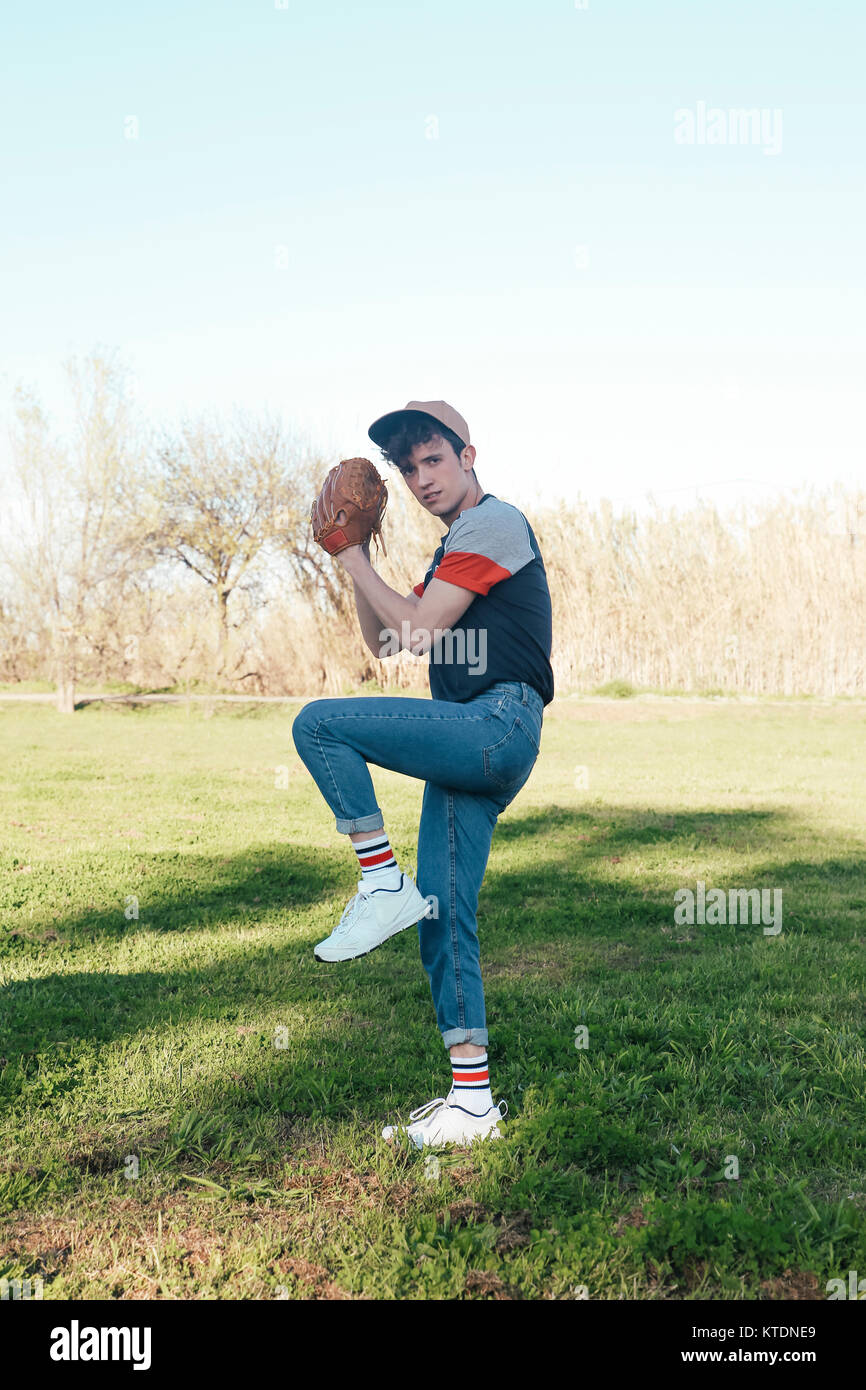 Young man playing baseball in park Stock Photo - Alamy