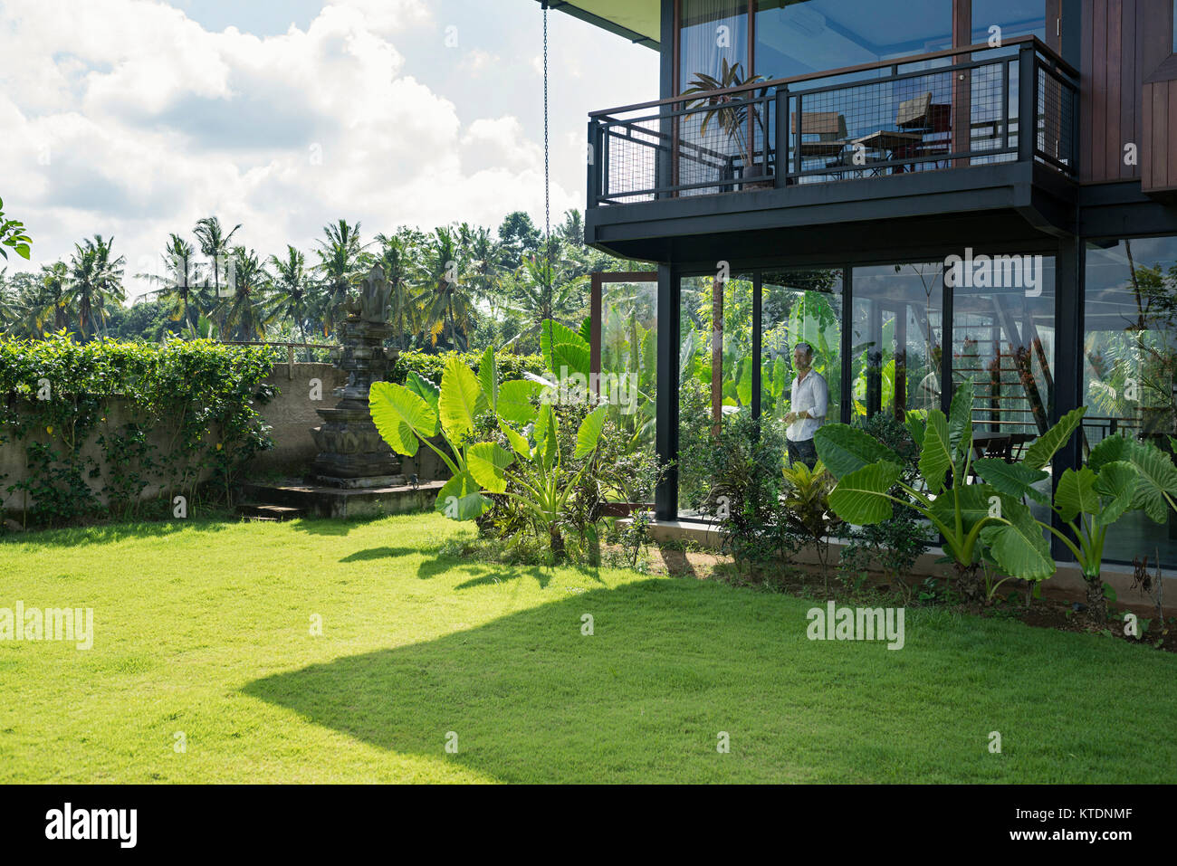 Mature man standing in his modern house, looking through window Stock ...