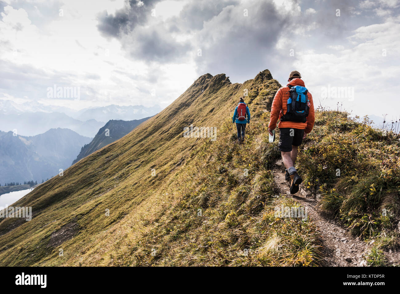 Germany, Bavaria, Oberstdorf, two hikers walking on mountain ridge ...