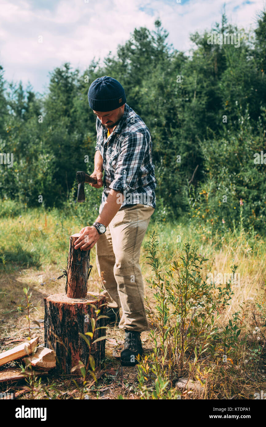 Man chopping wood in rural landscape Stock Photo - Alamy