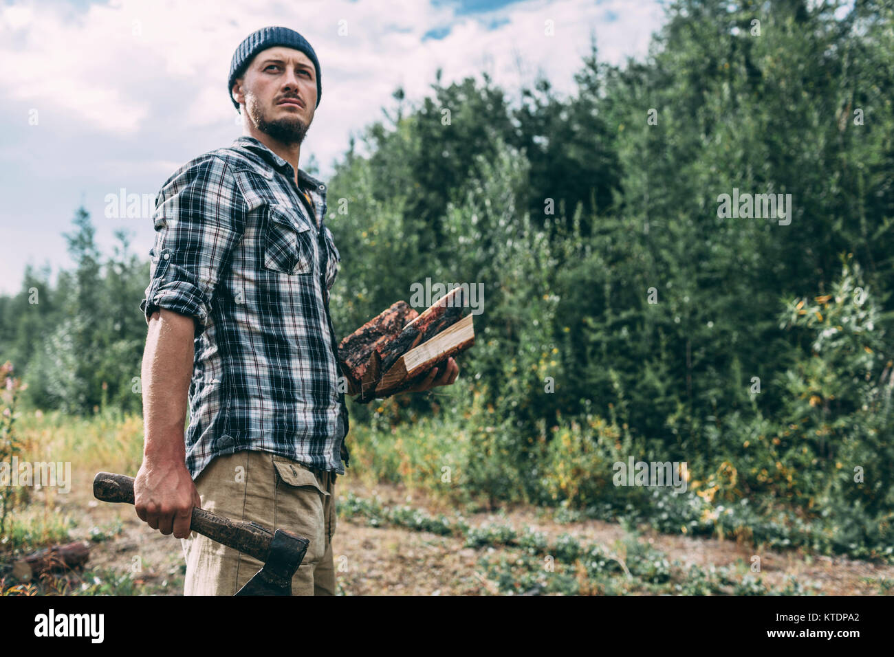 Man chopping wood in rural landscape Stock Photo - Alamy